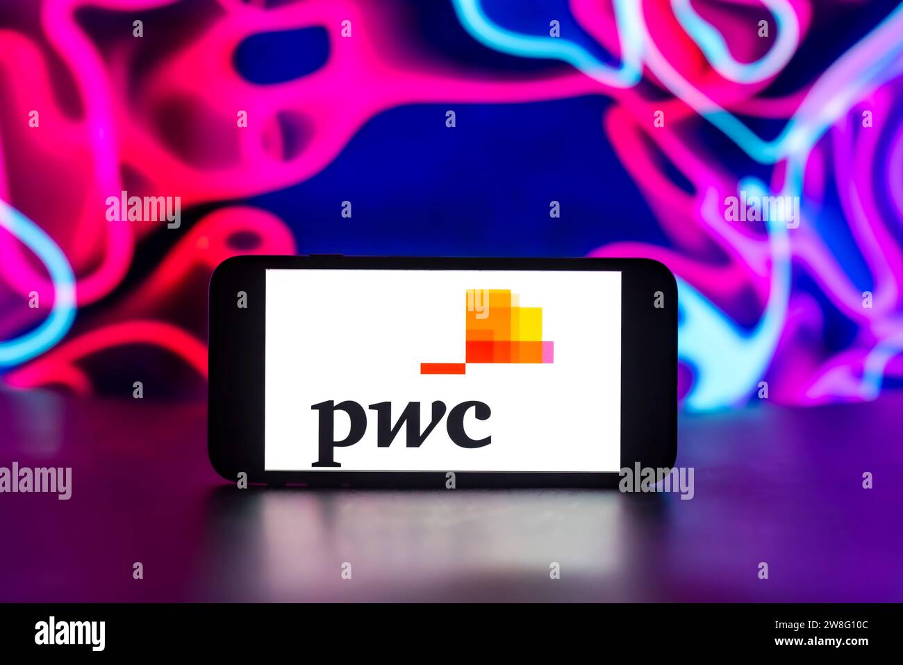 In this photo illustration, the PWC logo is seen displayed on a mobile ...
