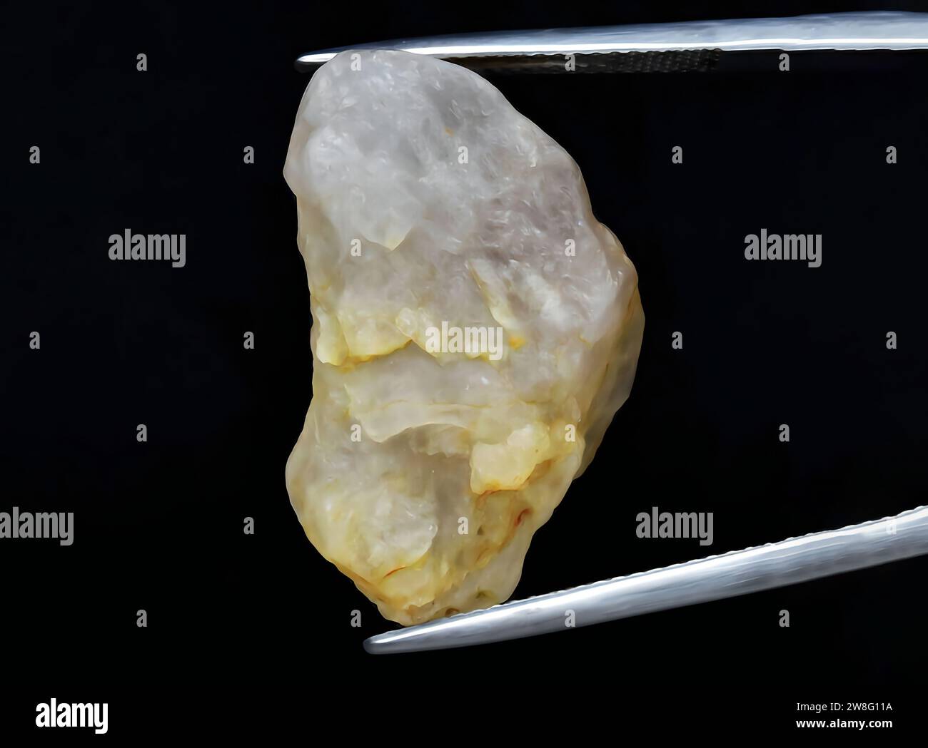 natural white spinel rough gem on background Stock Photo - Alamy