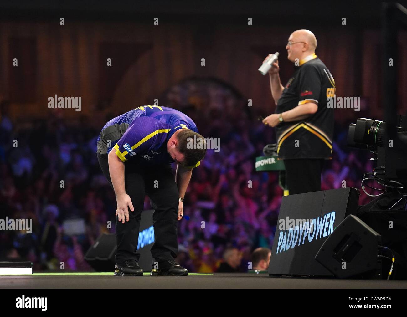 Luke Littler reacts after beating Andrew Gilding (not pictured) on day ...