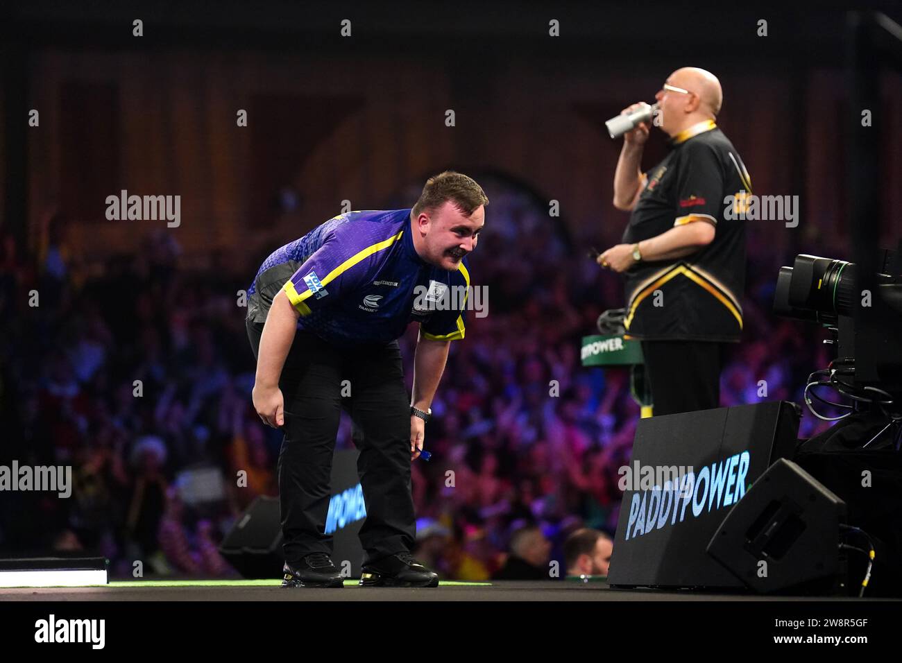 Luke Littler reacts after beating Andrew Gilding (not pictured) on day ...