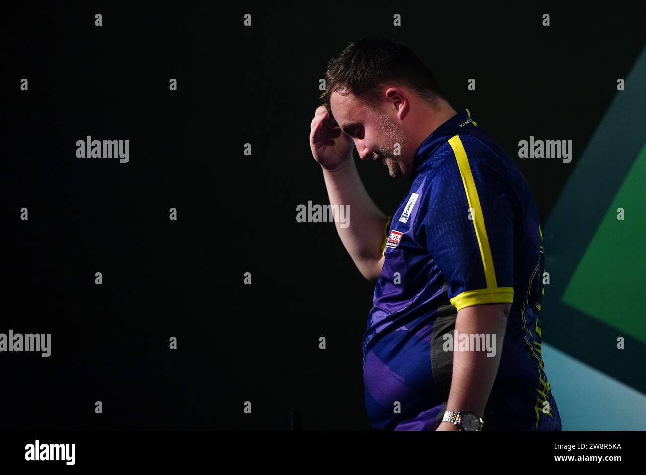 Luke Littler reacts after beating Andrew Gilding (not pictured) on day ...