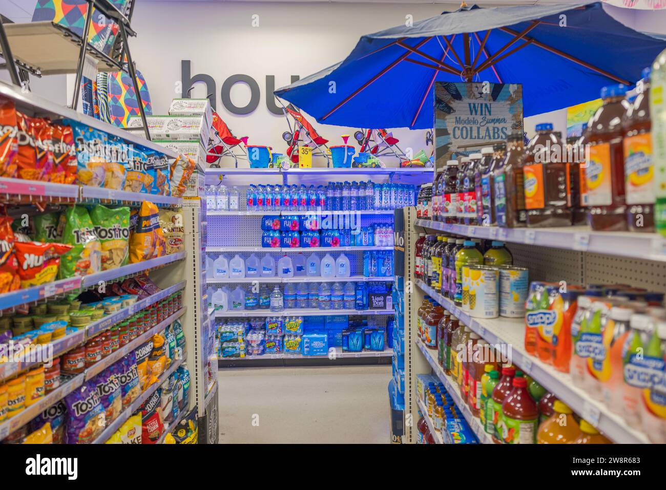 Close-up view of shelves with bottles and packs of water in a CVS store ...