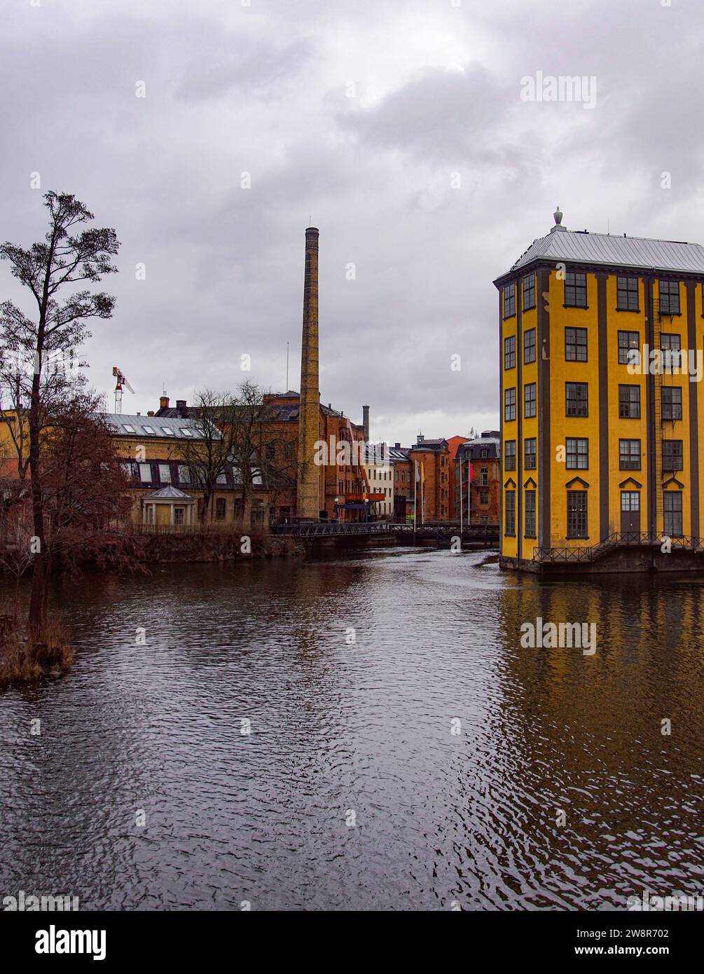 View of old industrial buildings next to river Stock Photo - Alamy