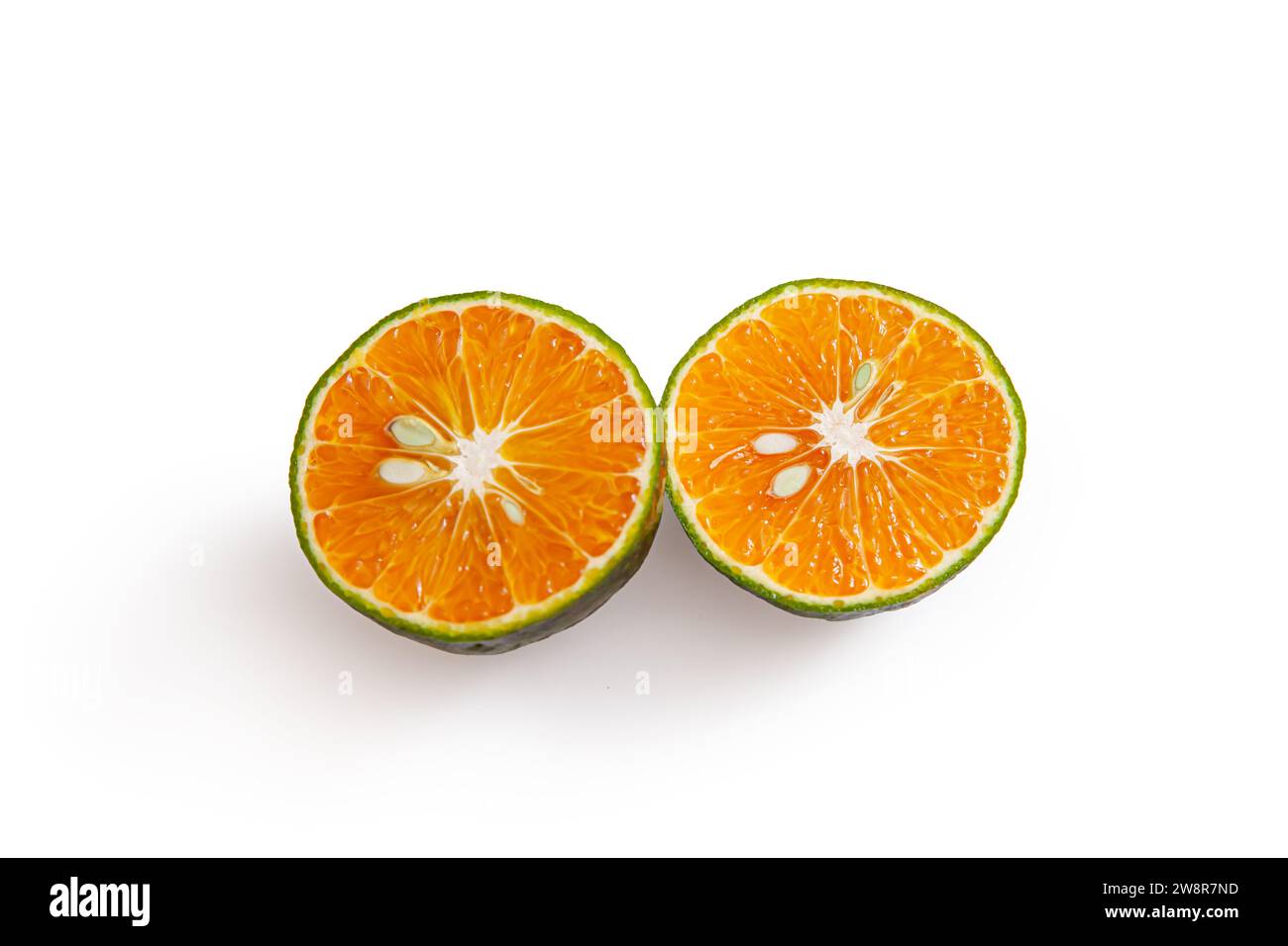 Orange with green peel cut in half isolated on white background Stock ...