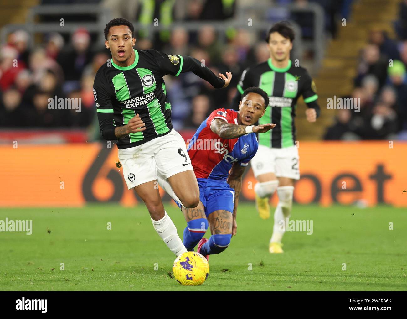 London, UK. 21st Dec, 2023. João Pedro of Brighton holds off Nathaniel ...