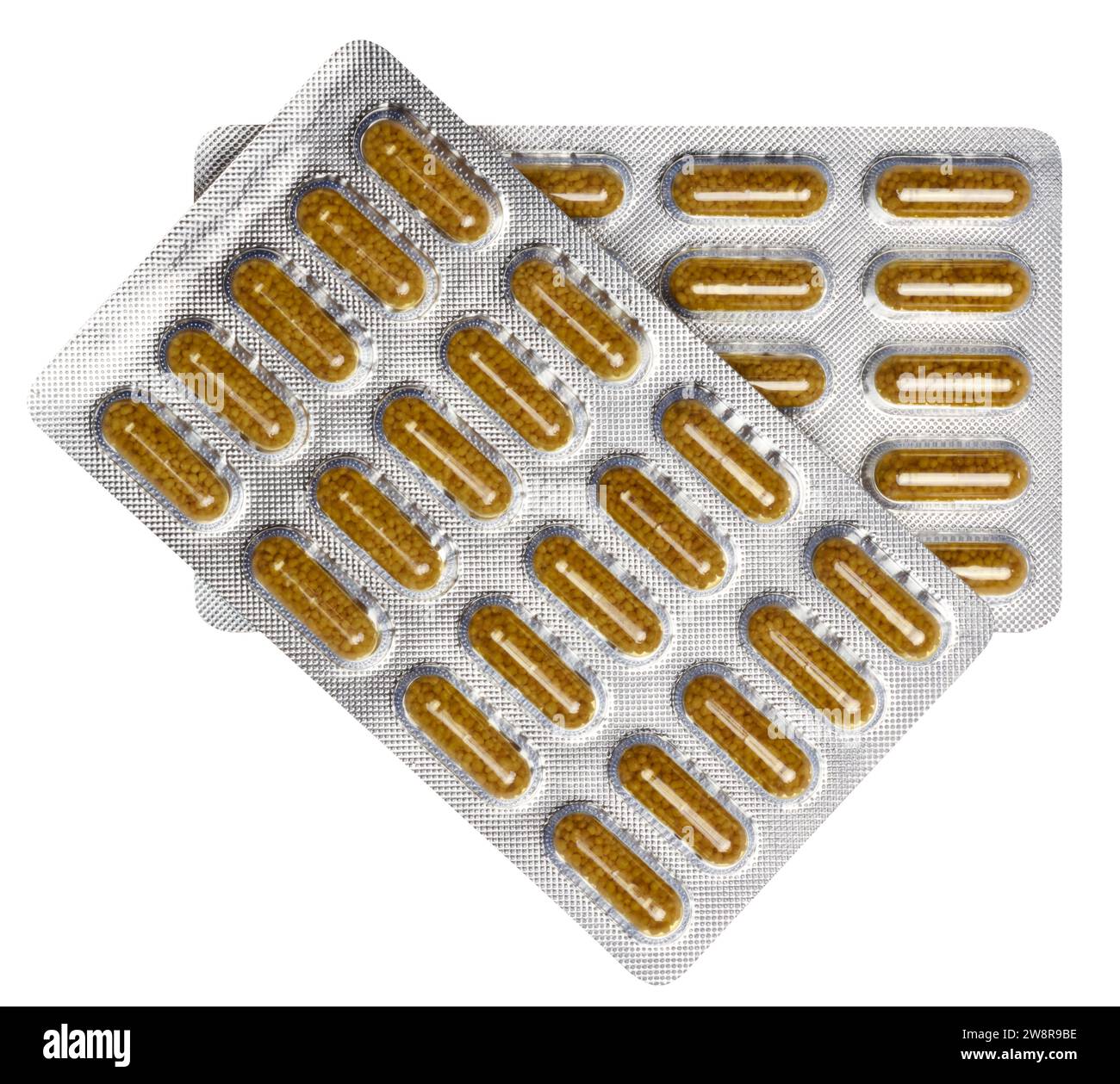 Oval tablets with yellow granules in blister pack on a white isolated ...
