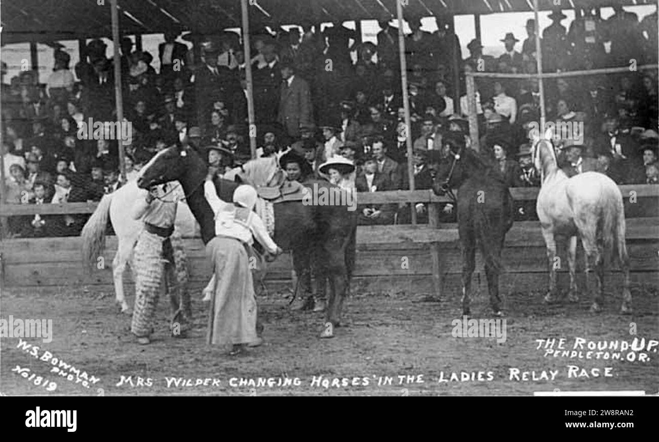 Woman changing horses in a relay race at the Round-Up, Pendleton ...