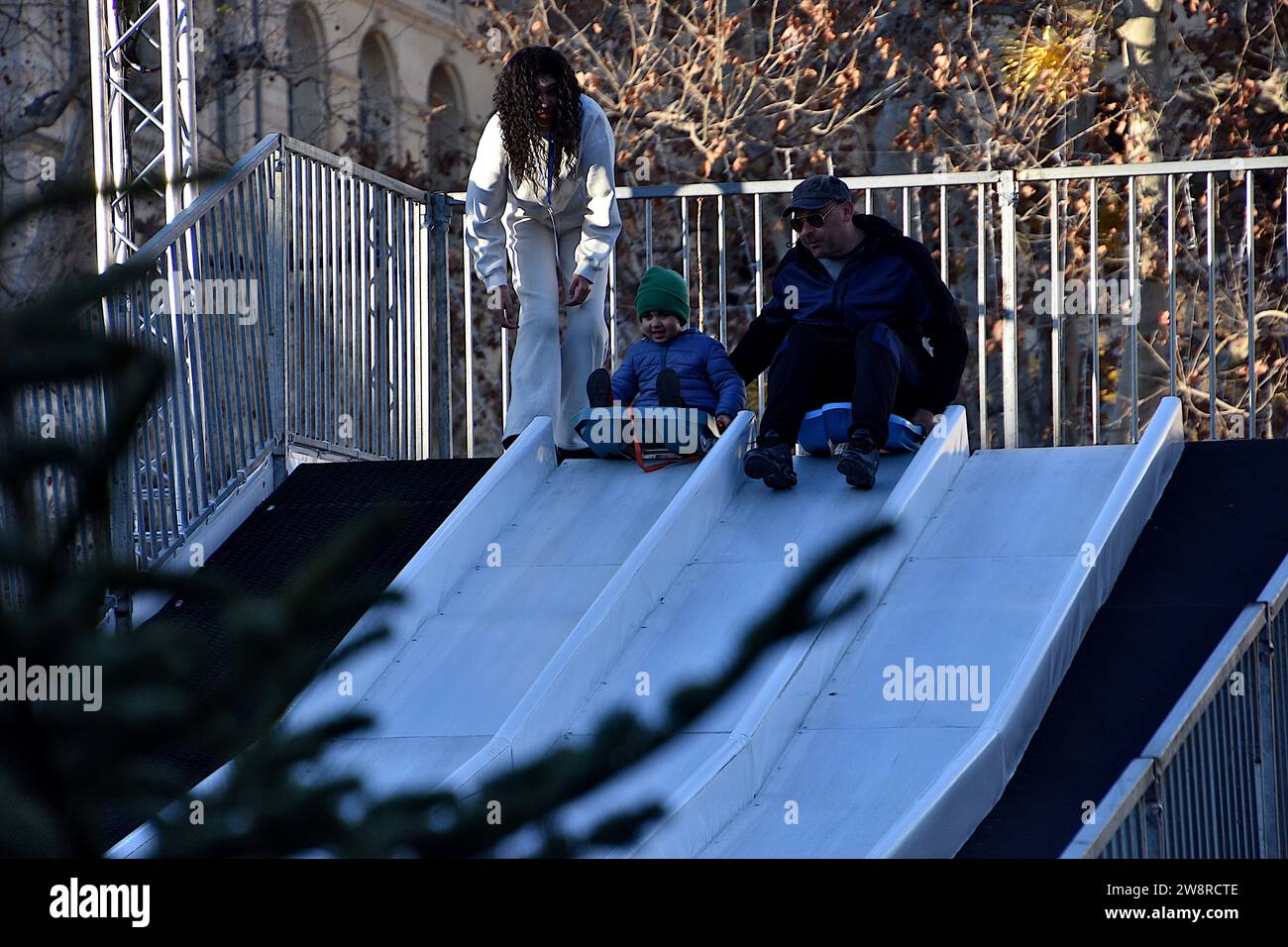A father and his child slide down a synthetic toboggan run. For the end ...