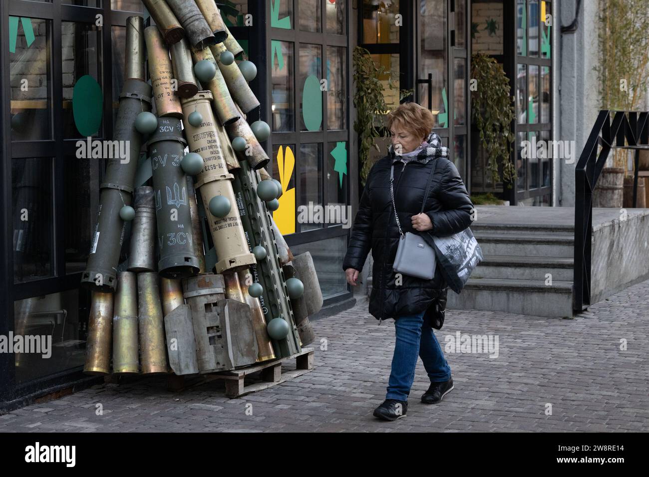 Kyiv, Ukraine. 20th Dec, 2023. A woman walks past a symbolic Christmas ...