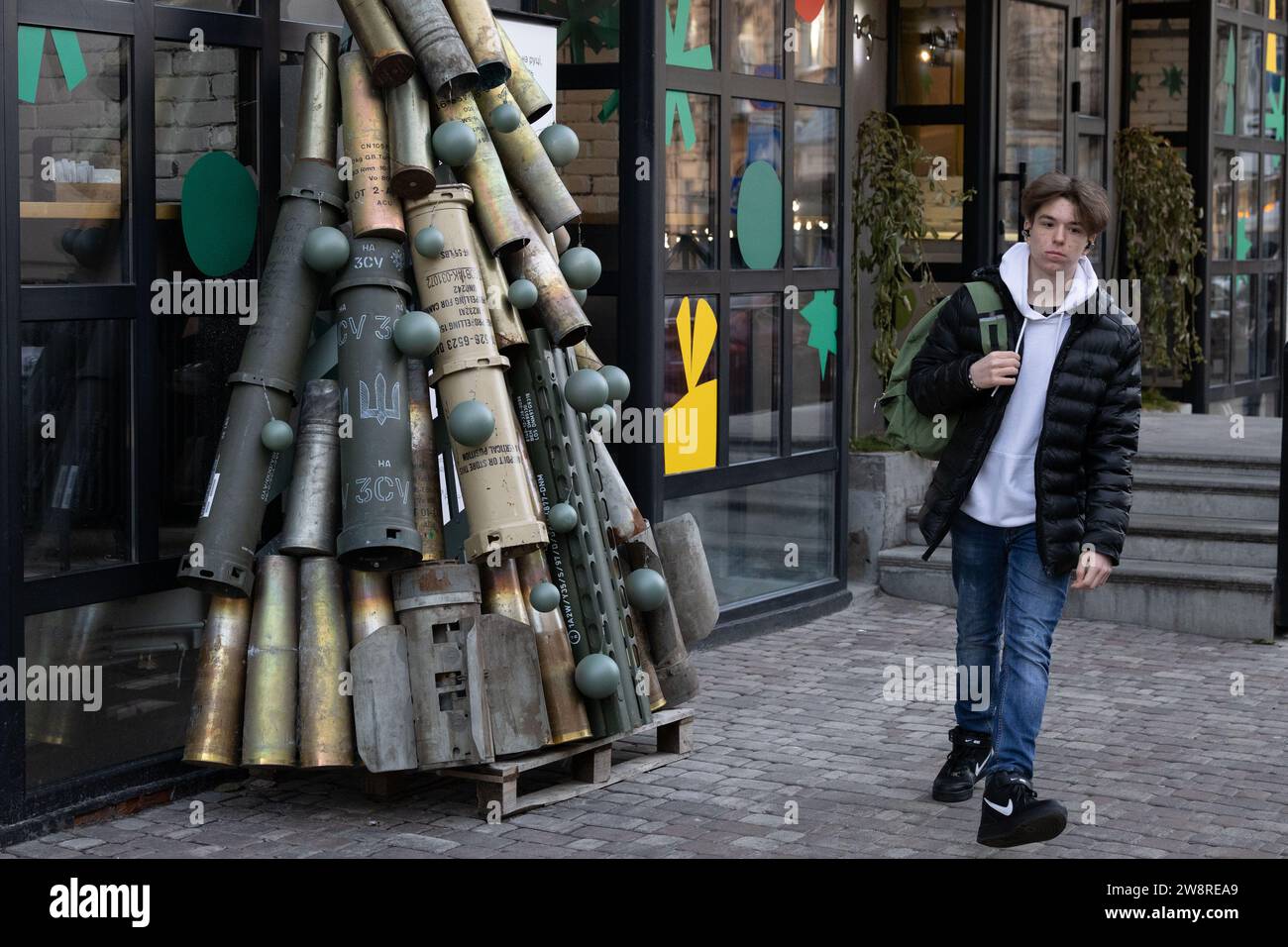 Kyiv, Ukraine. 20th Dec, 2023. A boy walks past a symbolic Christmas ...