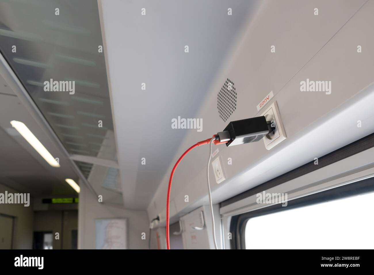 adapter for charging phones and gadgets Plugged in the 220-volt socket ...