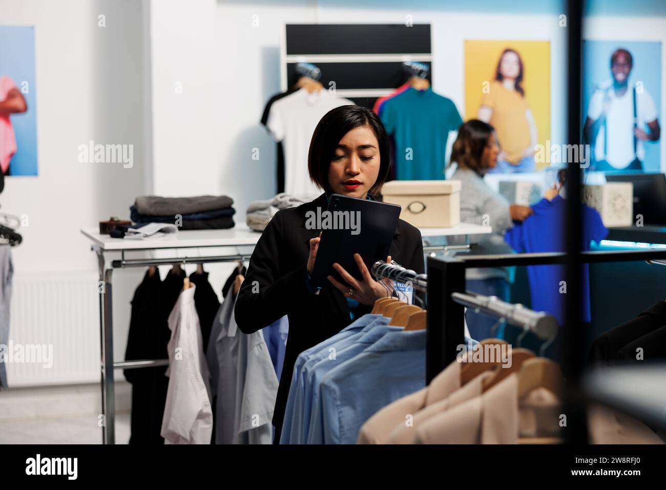 Clothing store asian woman manager checking stock and inventory using ...