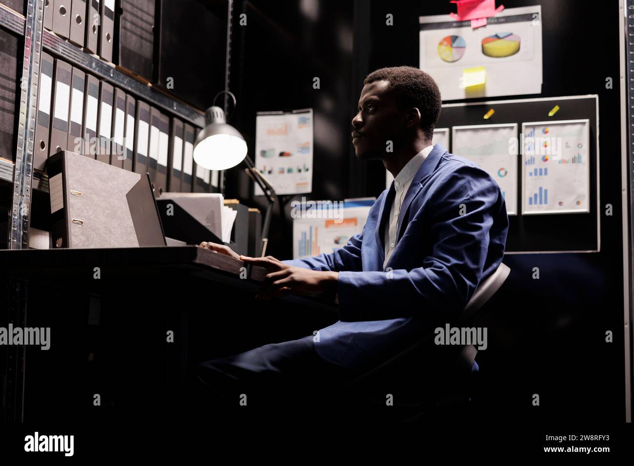 African American Detective Reading Police Expertise Working Overtime At Criminal Case In Arhive