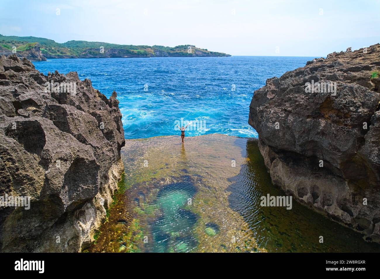 A cliff broken by the wave of the ocean. Natural azure bathing pool in ...