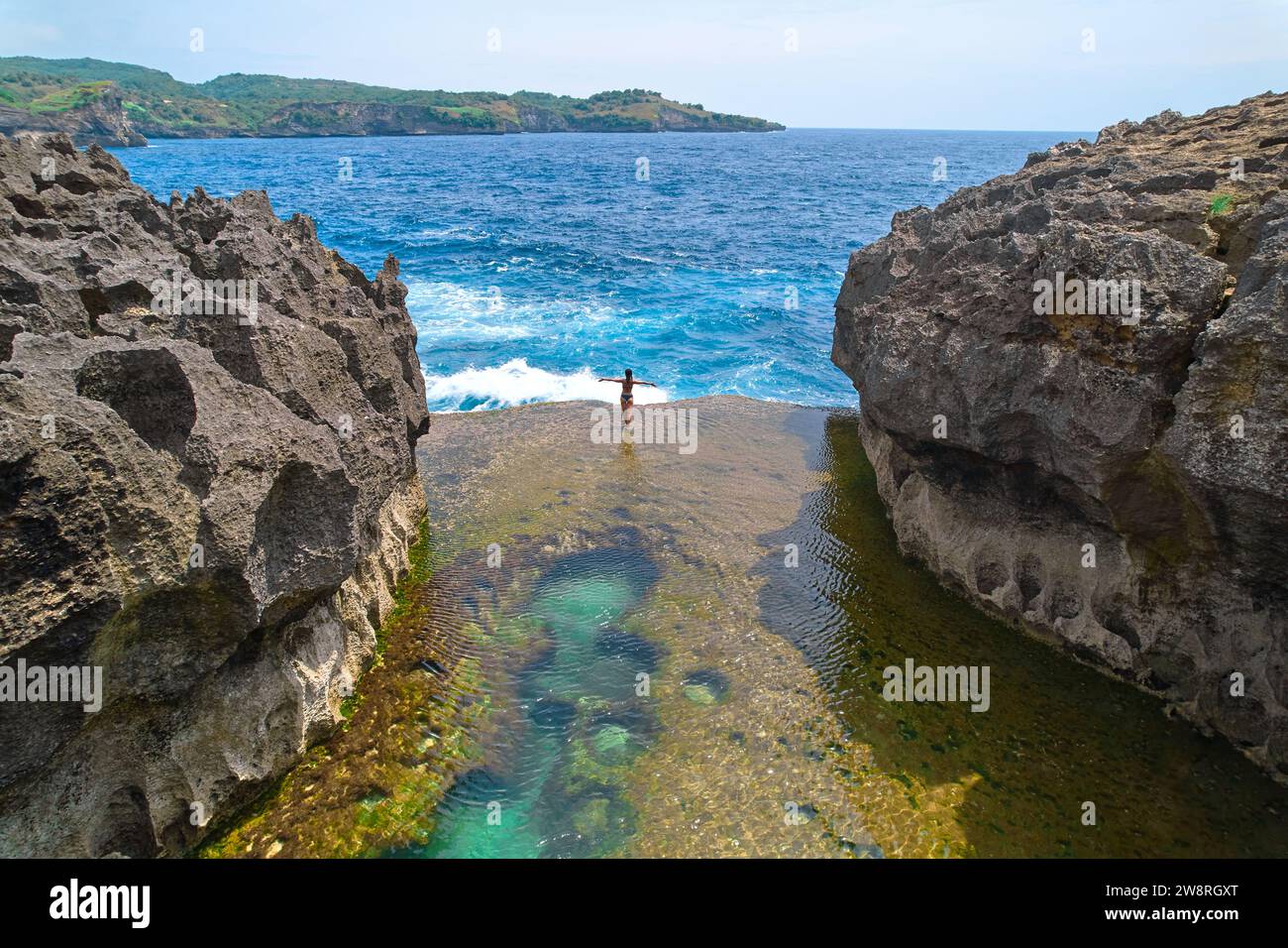 A cliff broken by the wave of the ocean. Natural azure bathing pool in ...