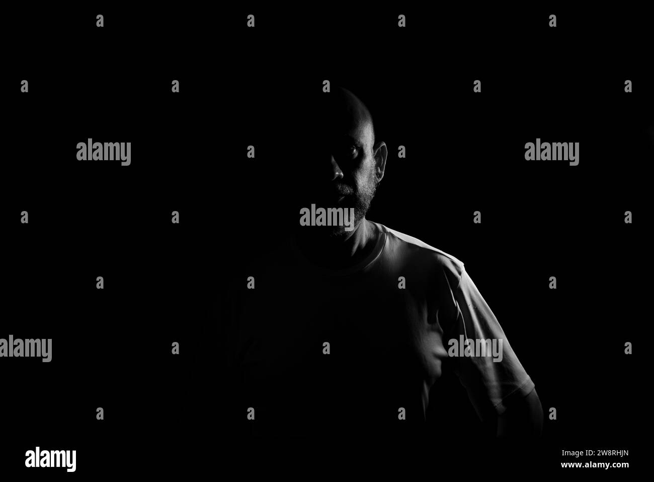 Low light portrait of bearded, bald man. Dark background Stock Photo ...