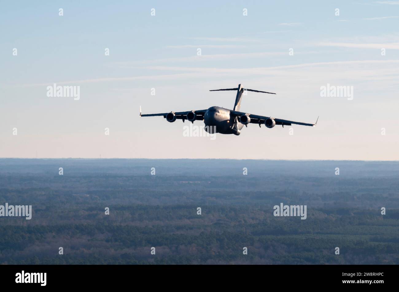 A C-17 Globemaster III assigned to the 437th Airlift Wing flies over a ...
