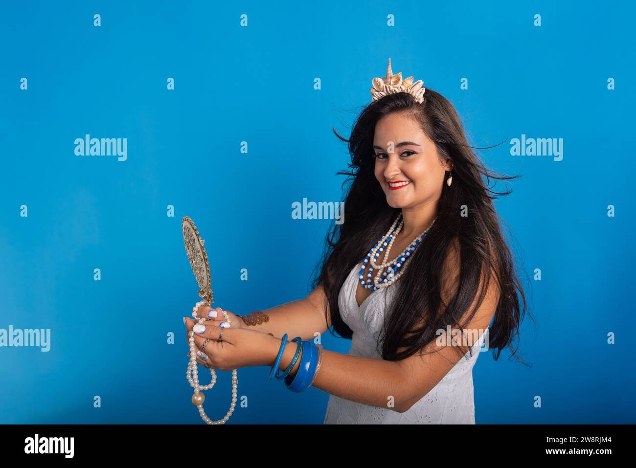 Portrait of beautiful black-haired woman wearing white clothes, smiling ...