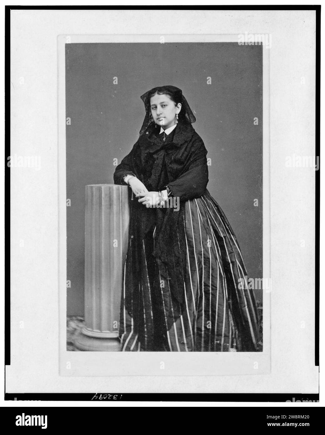 Woman wearing shawl, full-length portrait, standing facing front, with ...