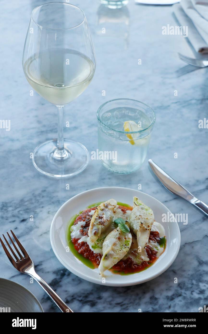 italian food pasta dish with pairing wine on a dining table for food ...