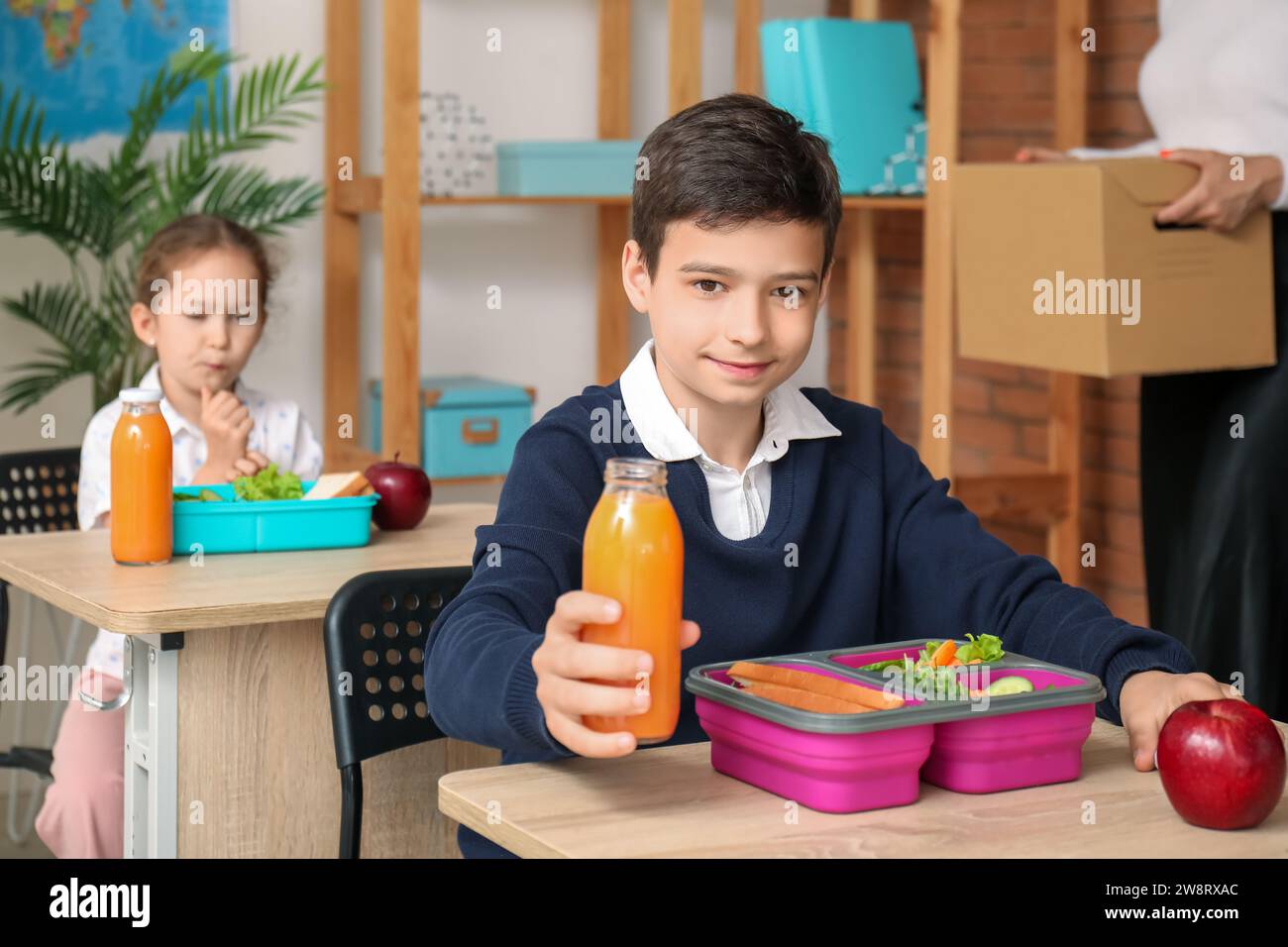 School boy and girl drink juice hi-res stock photography and images - Alamy