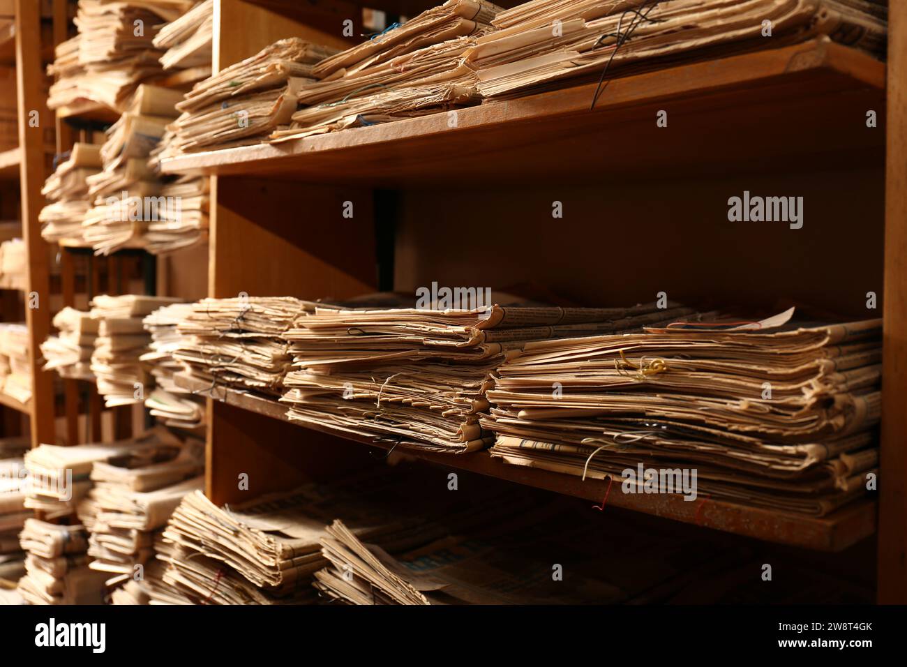 Collection of old newspapers on shelves in library Stock Photo - Alamy