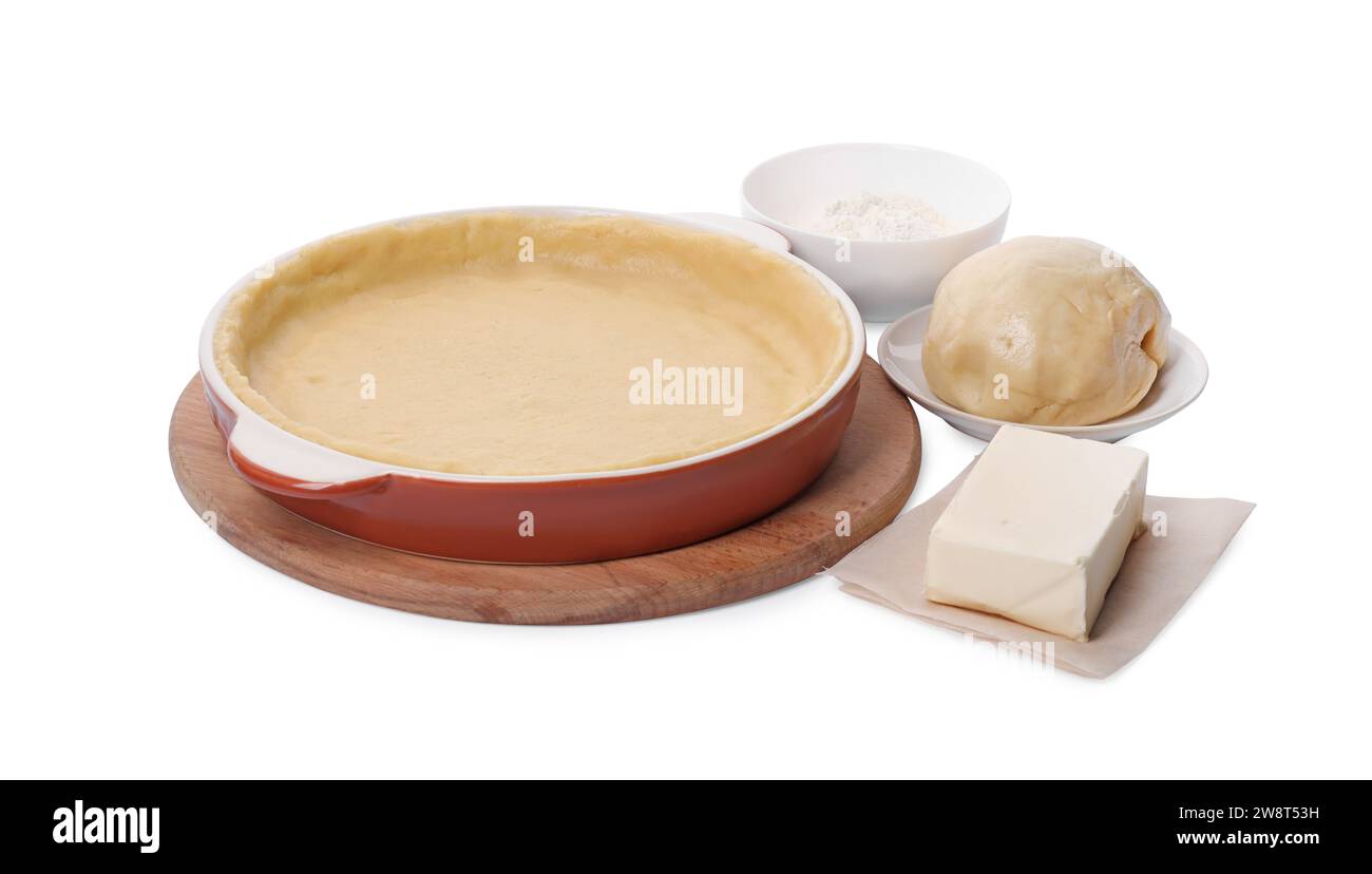 Pie tin with fresh dough and ingredients isolated on white. Making ...