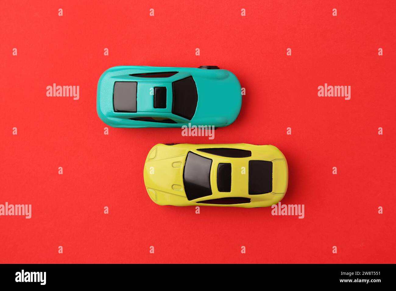 Different bright cars on red background, flat lay Stock Photo - Alamy
