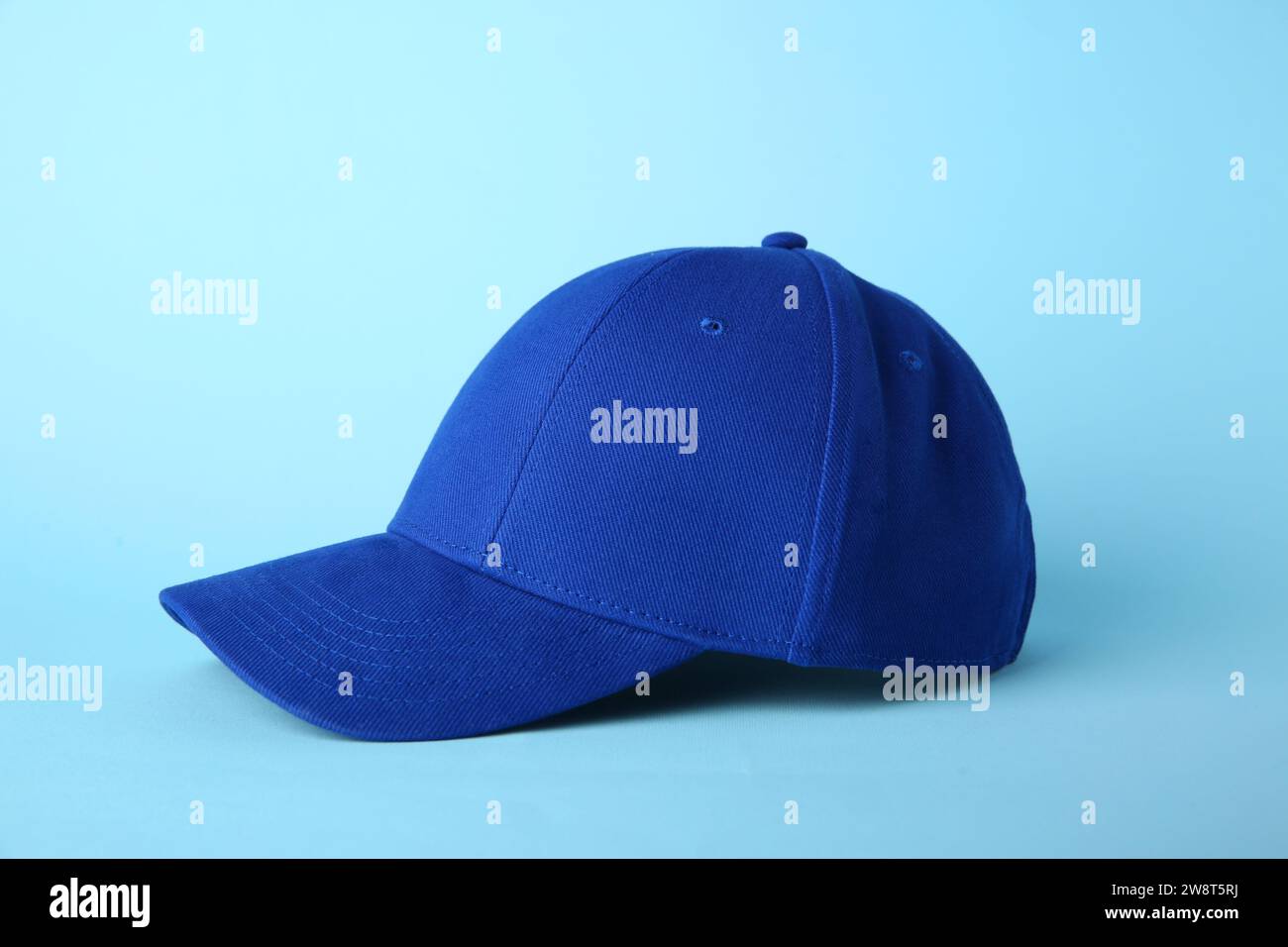 Stylish baseball cap on light blue background Stock Photo - Alamy