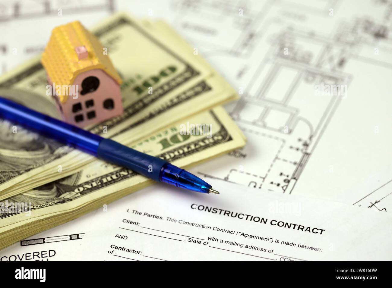 Residential construction agreement ready to sign with small toy houses ...