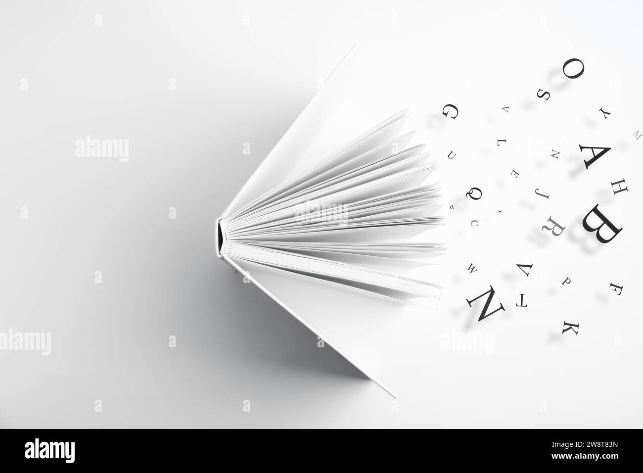 Open book with letters flying out of it on white background, top view Stock Photo - Alamy