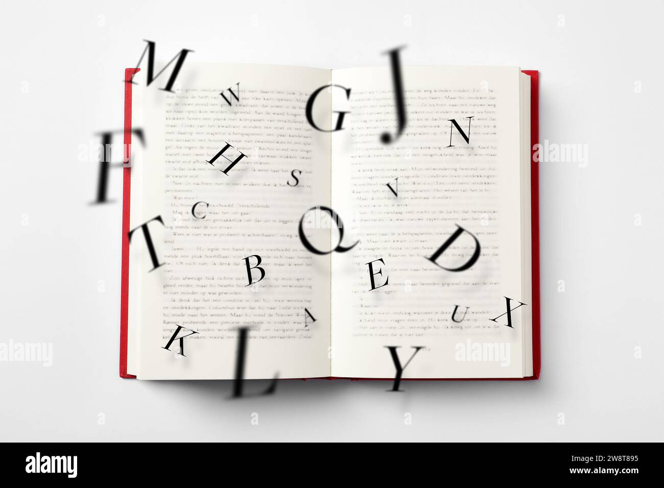 Open book with letters flying out of it on white background, top view Stock Photo - Alamy
