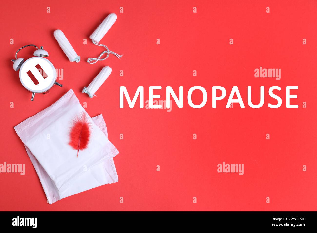 Menopause word, alarm clock with pause symbol, tampons and pads on red ...
