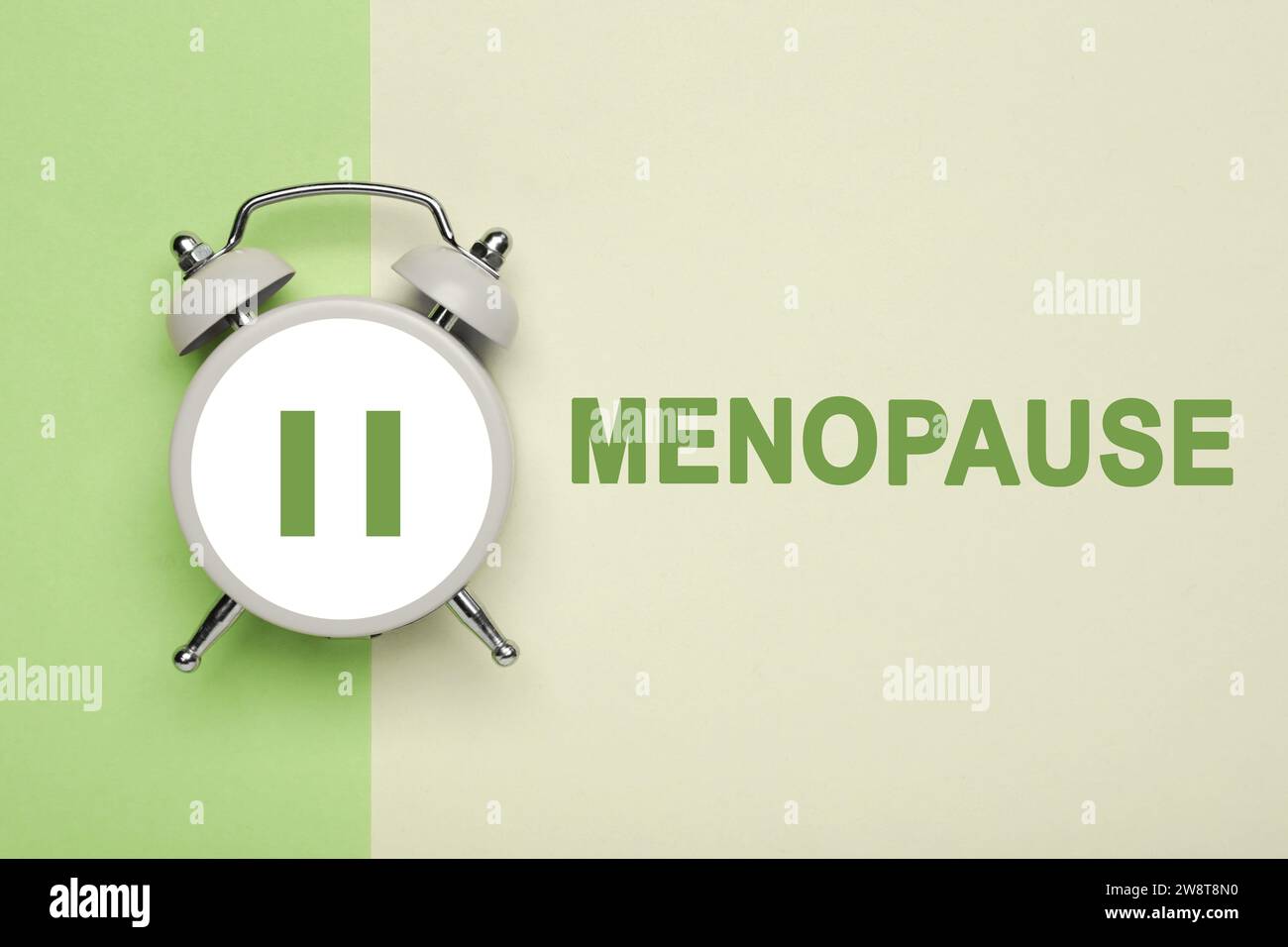 Menopause word and alarm clock with pause symbol on color background ...