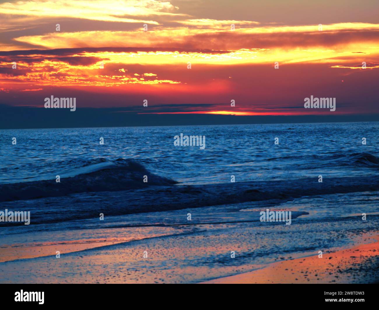 Sunset sky and waves on the Gulf of Mexico Stock Photo - Alamy