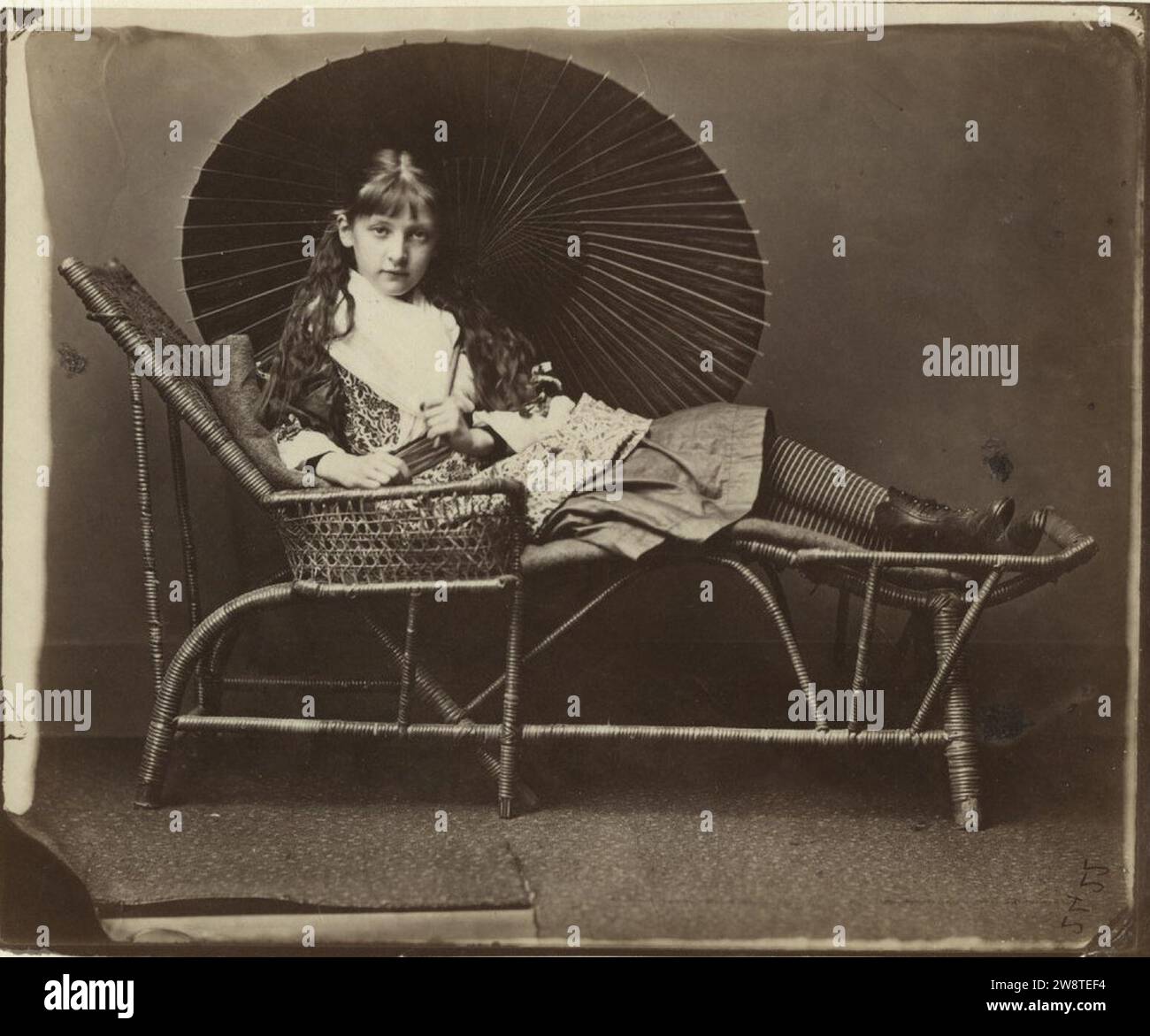 Xie Kitchin partly in the Penelope Boothby dress, on a garden chair ...