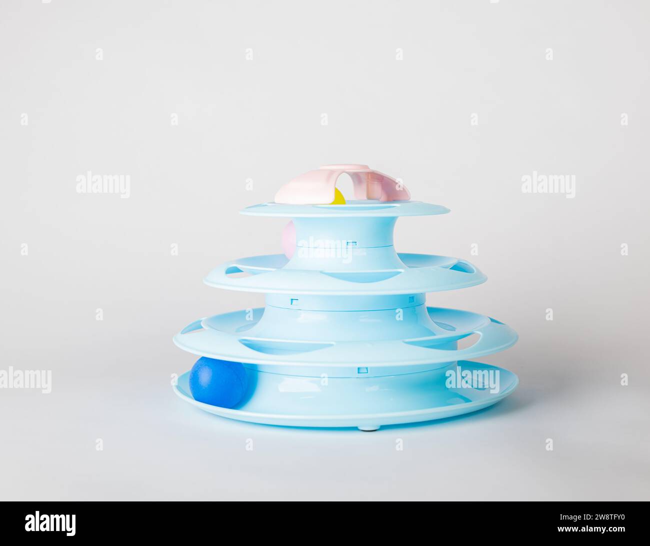 Cat's playtime showcased, a blue tower toy with a circular turntable ...