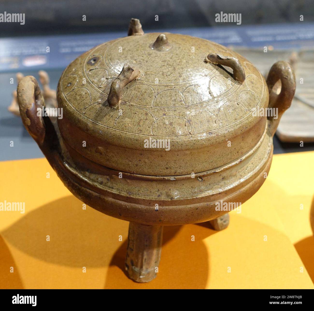 Yellowish-green glazed pottery tripod with cover, Eastern Han dynasty ...