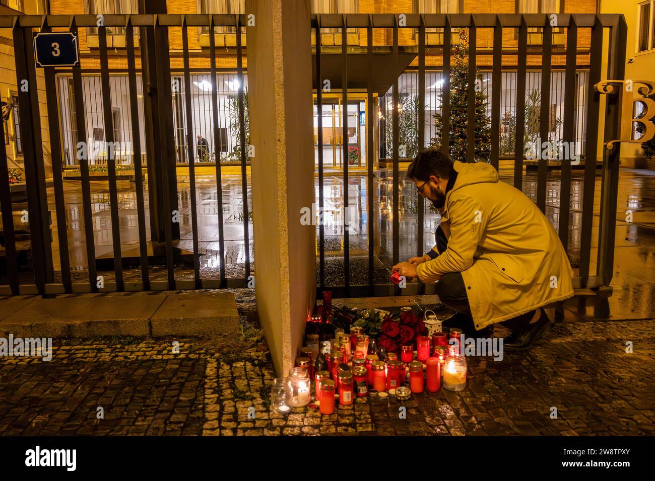 Prague, Czech Republic. 21st Dec, 2023. A man lights candles in front ...