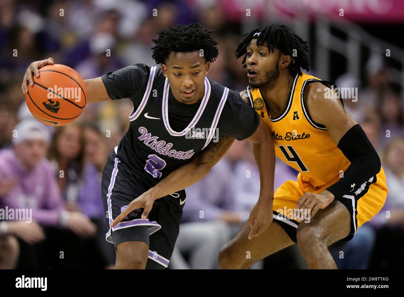 Kansas State guard Tylor Perry (2) drives under pressure from Wichita ...