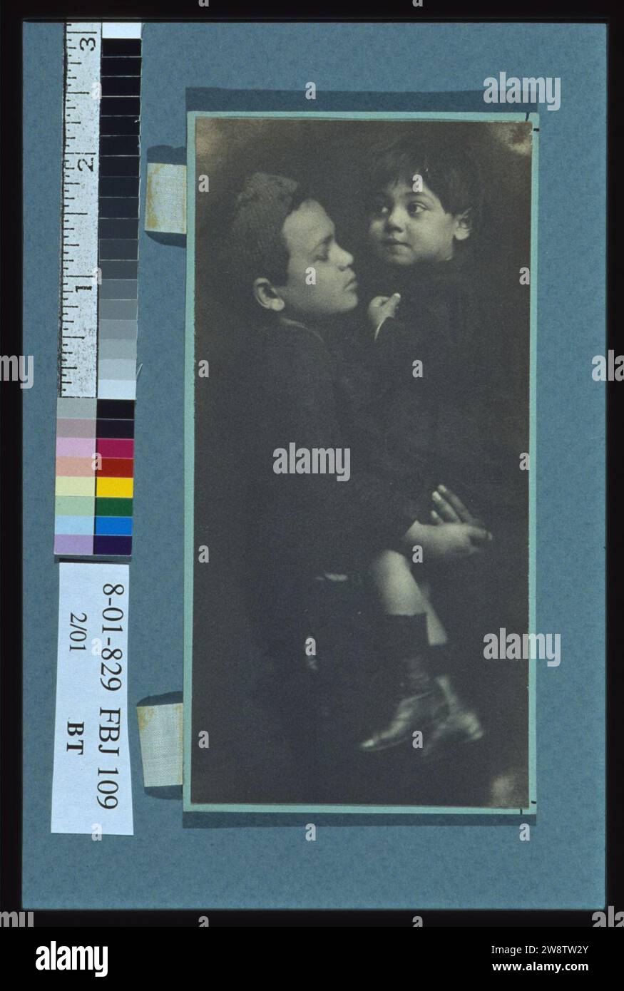 Young boy holding a smaller child Stock Photo - Alamy