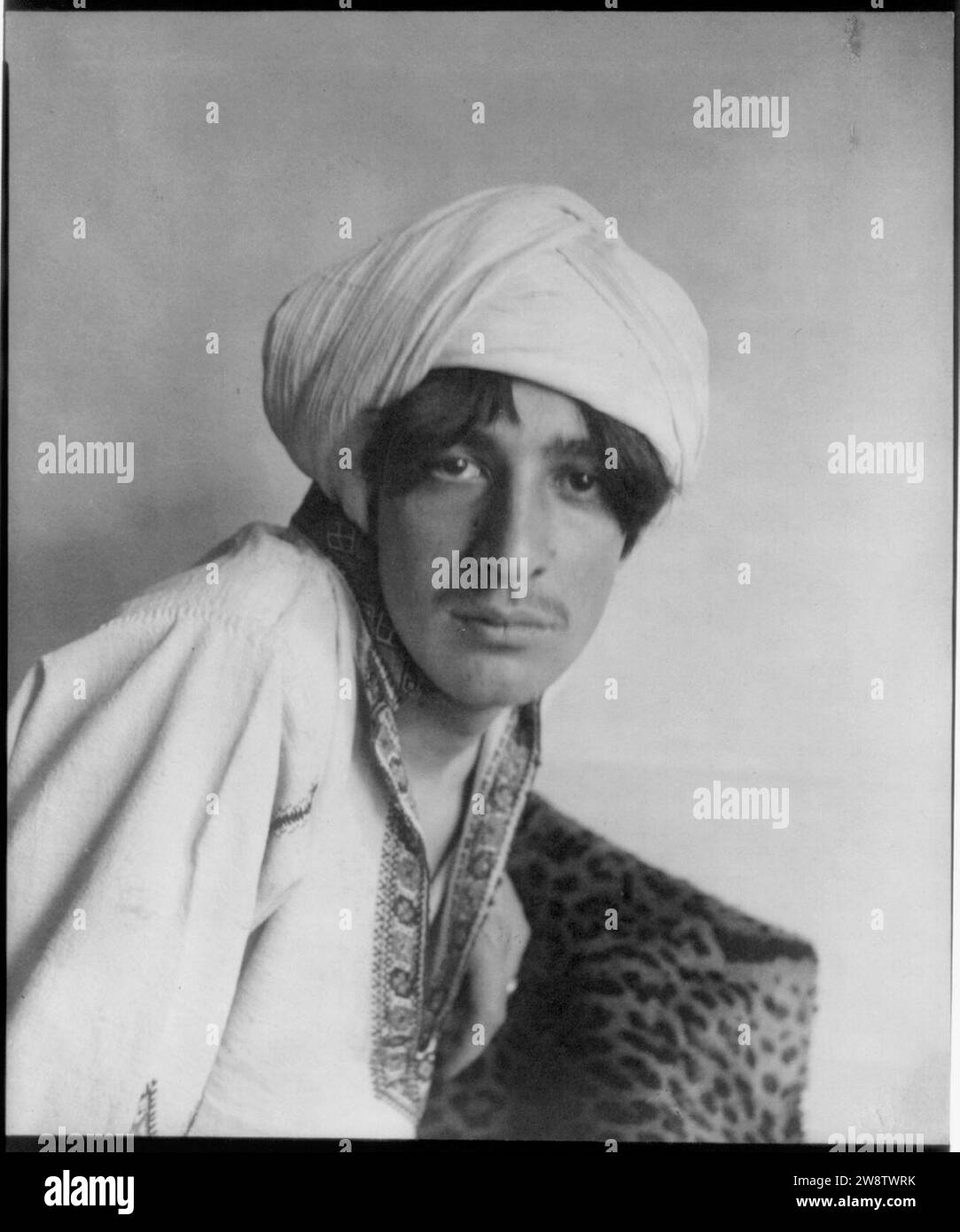 Young man in Middle-Eastern costume, with turban and leopard skin, in ...