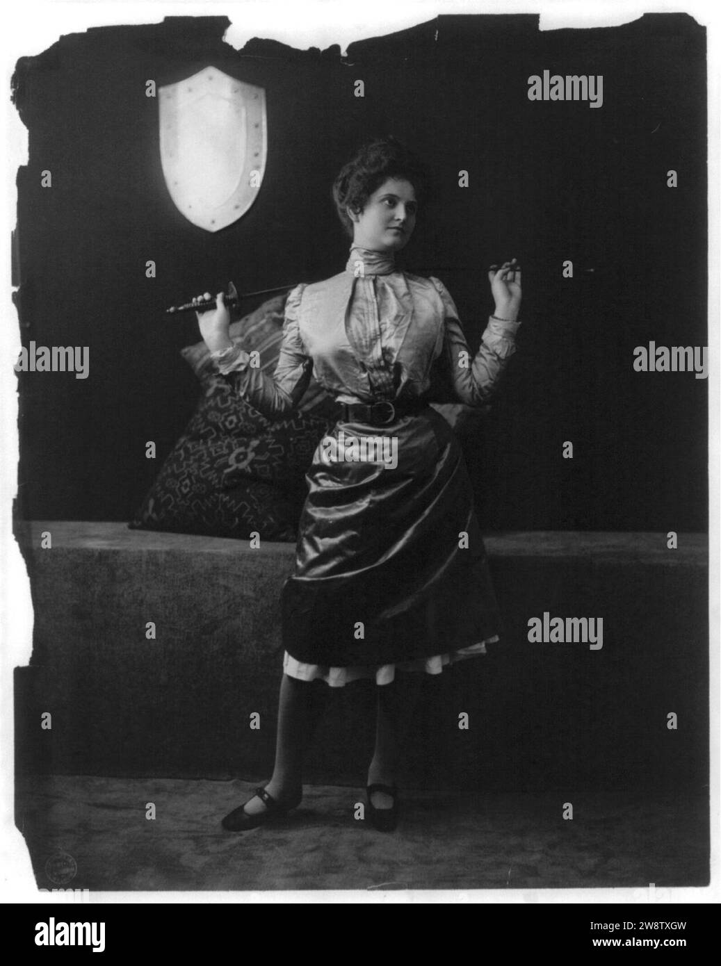 Young women modeling- full lgth., holding sword behind shoulders Stock ...