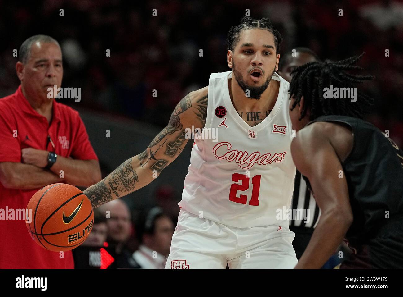 Houston guard Emanuel Sharp (21) is defended by Texas State guard ...