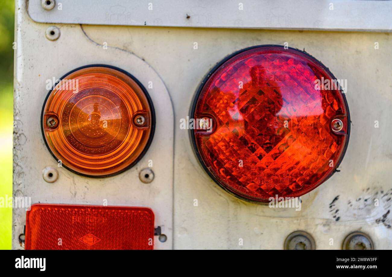 "Close-up of the orange turn signal and the rear fog light of the left ...