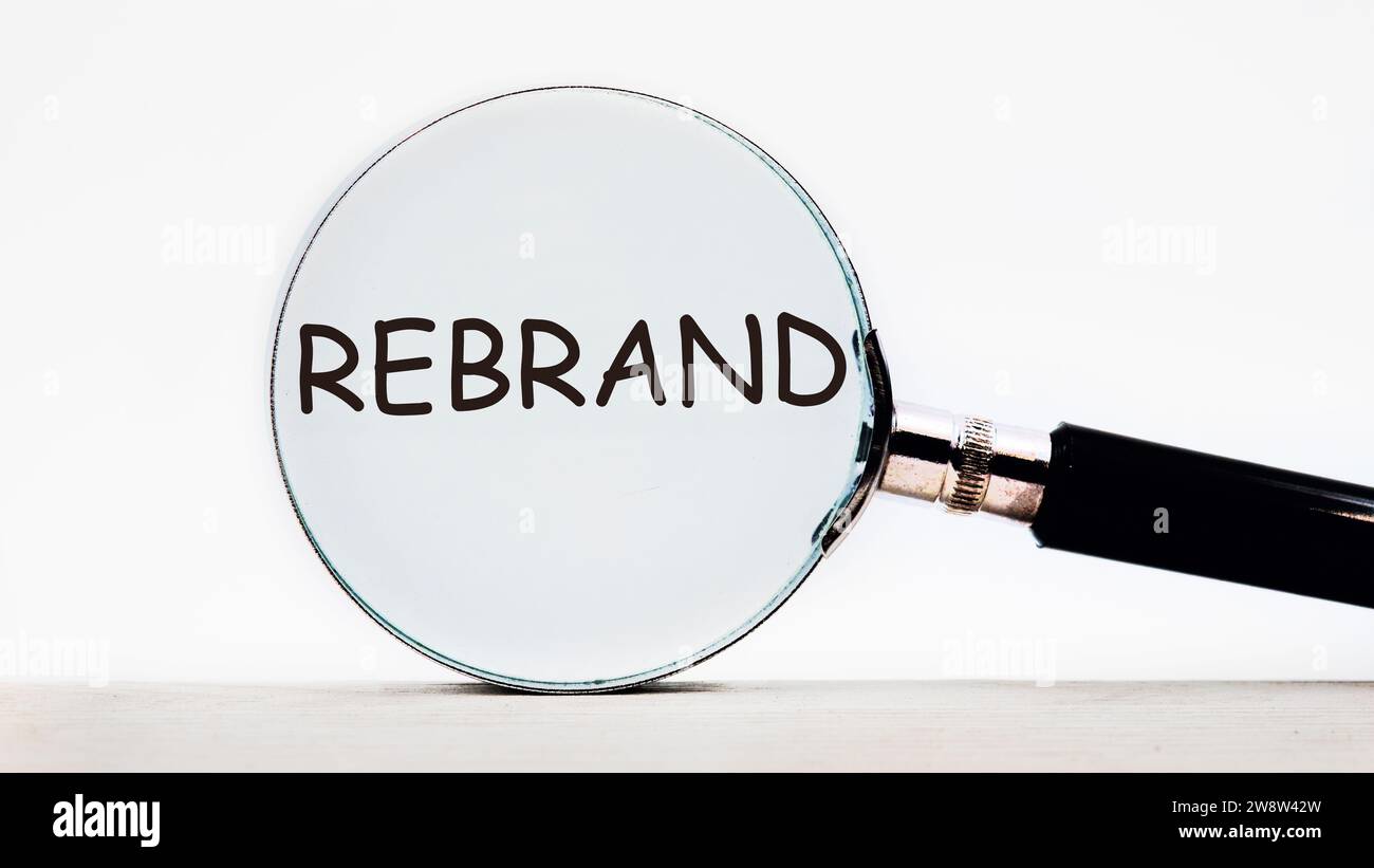 Rebrand lettering on through a magnifying glass on a light background ...