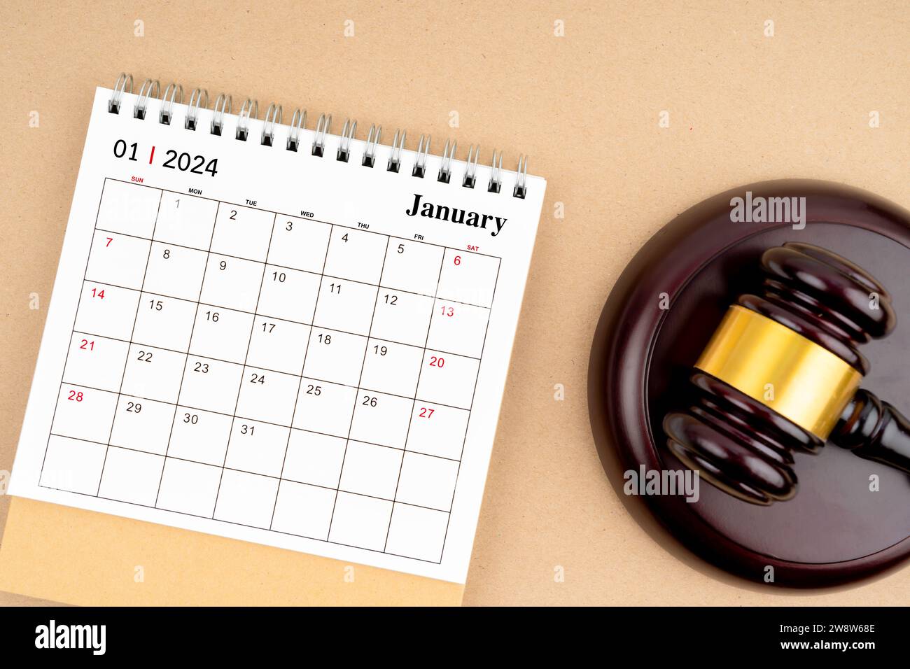 Desk calendar for January 2024 and judge's gavel on brown background ...