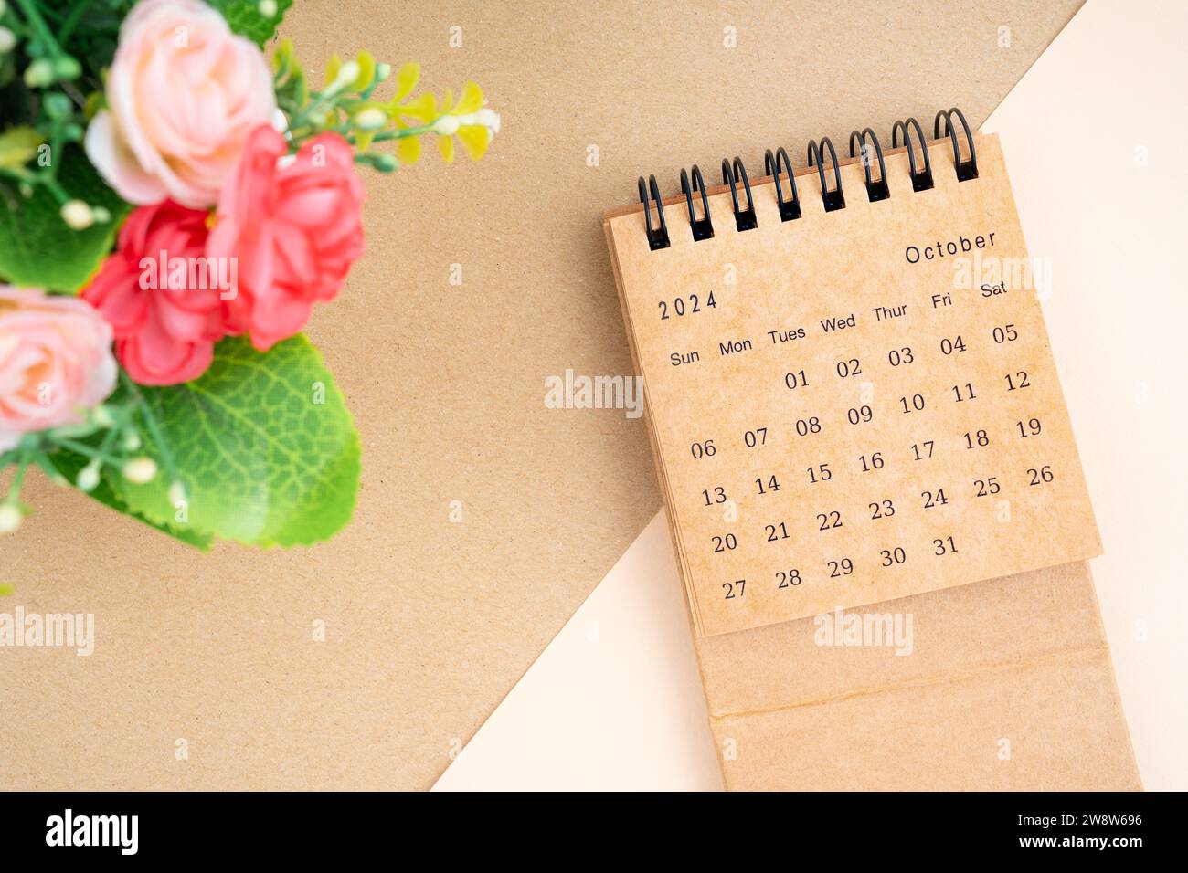 October 2024 Desk Calendar and flower on brown color background Stock ...