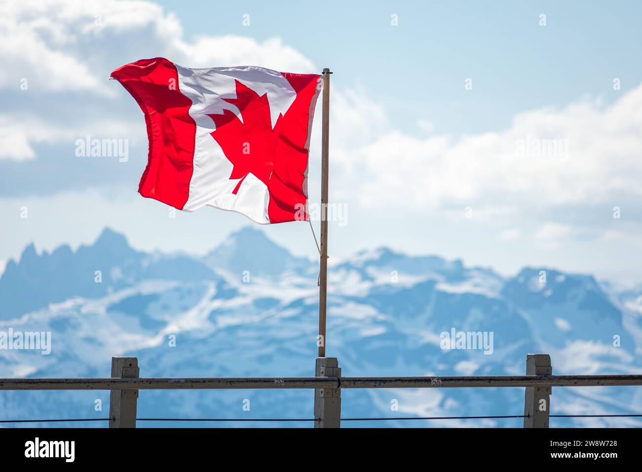 The Canadian flag flutters proudly against a backdrop of Whistler ...
