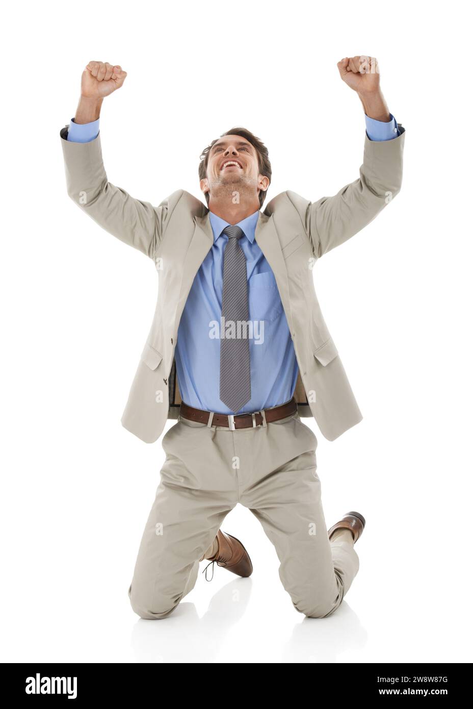 Business man, hands up in celebration and kneeling on ground for ...